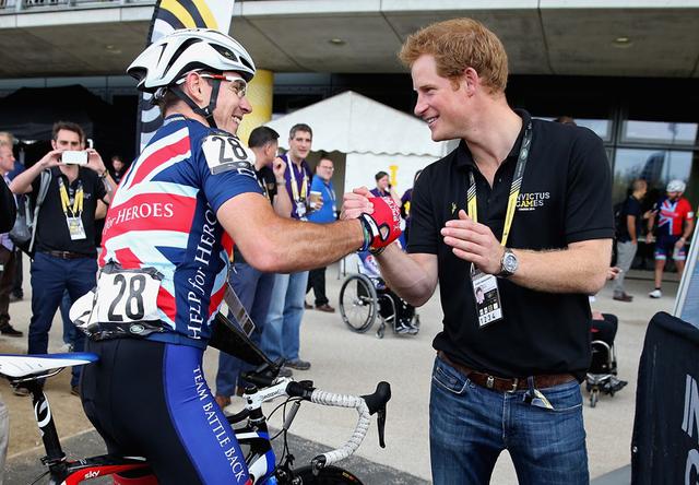 Prince Harry Is Cheered By A Member Of The Public As He Cycles Between ...
