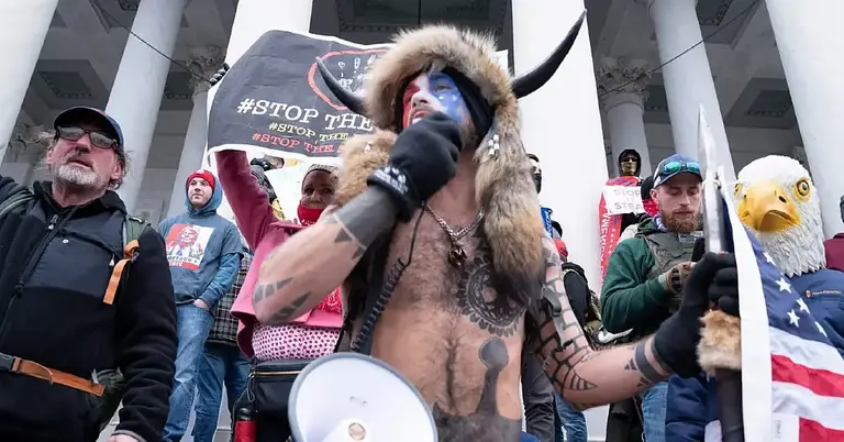 'QAnon Shaman' Files $40 Trillion Lawsuit Against Donald Trump