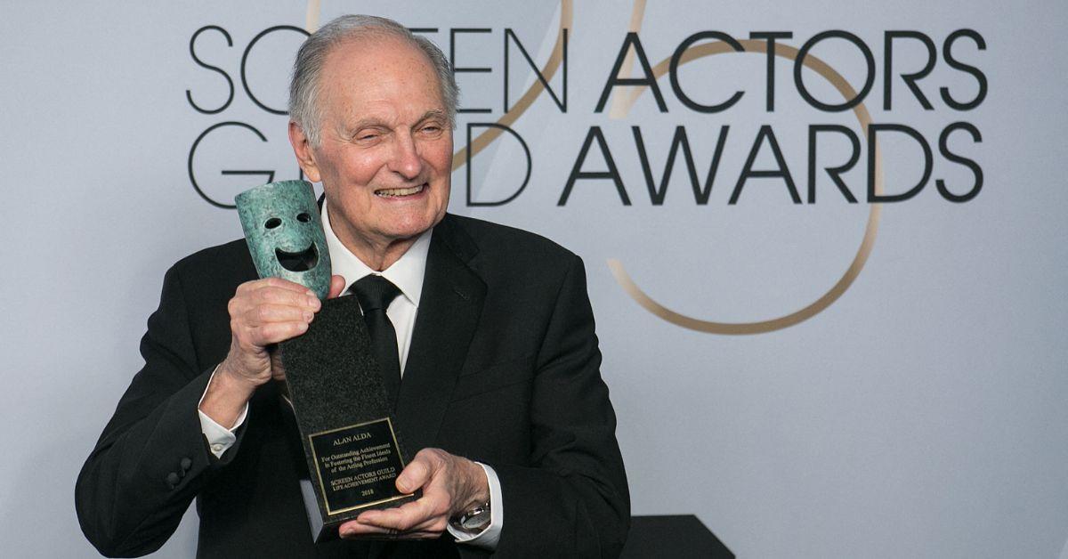 EXCLUSIVE: Alan Alda, 89, Confesses He Can’t Even Button Up a Shirt