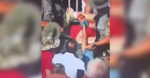 Donald Trump Stands and Raises his Fist in Defiance After Multiple ...