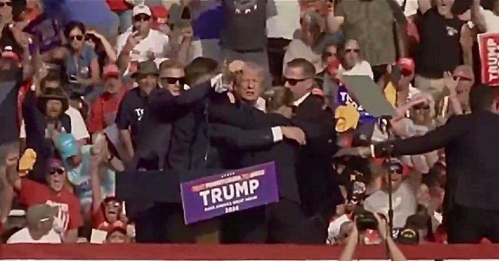 Donald Trump Stands and Raises his Fist in Defiance After Multiple ...