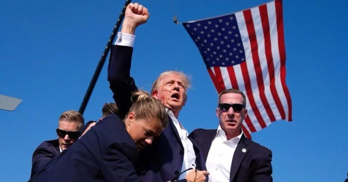 Donald Trump Stands and Raises his Fist in Defiance After Multiple ...