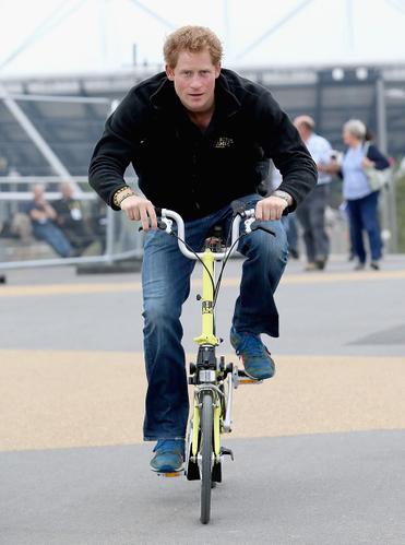 Prince Harry Is Cheered By A Member Of The Public As He Cycles Between ...
